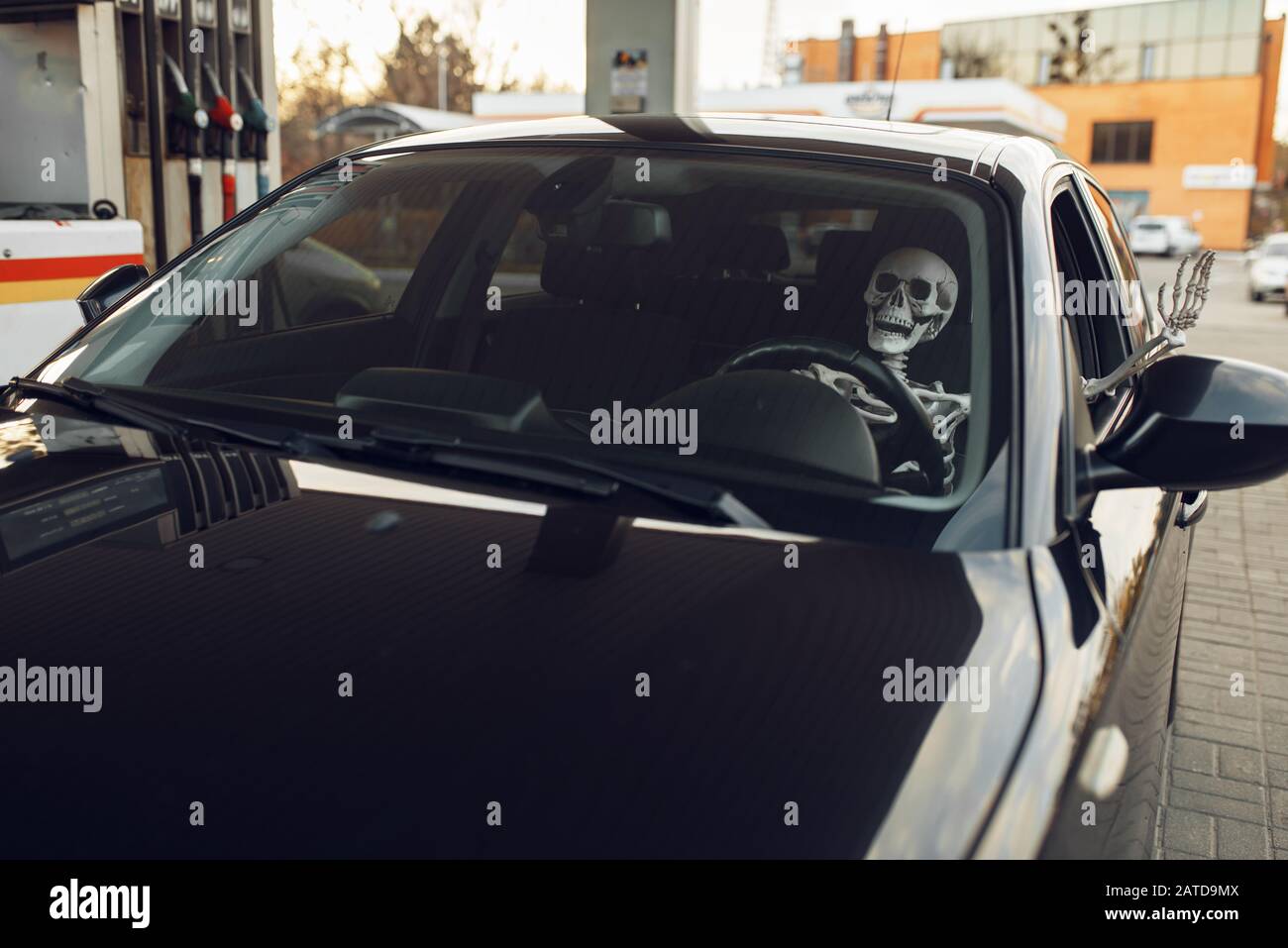 Skeleton in car, fueling on gas station Stock Photo - Alamy