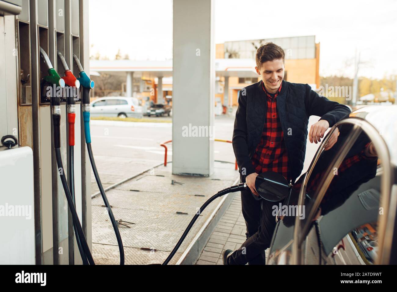 Man fuels vehicle on gas station, bottom view Stock Photo - Alamy