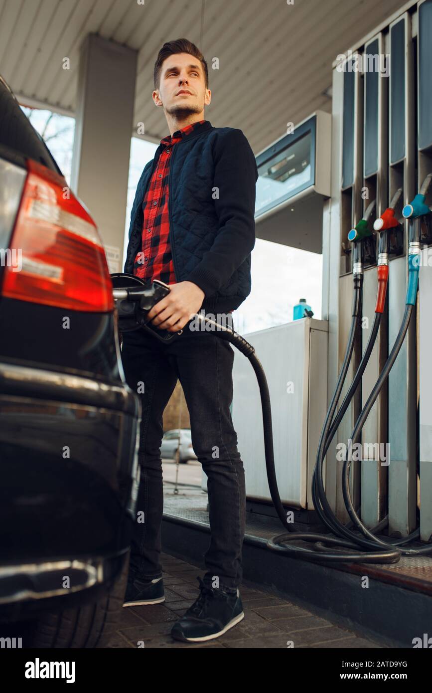 Man fuels vehicle on gas station, bottom view Stock Photo - Alamy