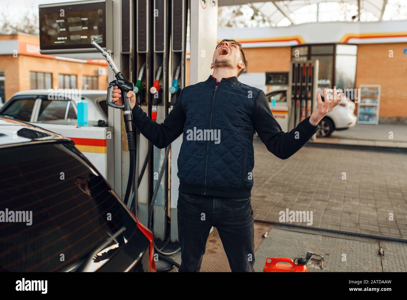 Depressed man cries on gas station, fuel filling Stock Photo - Alamy