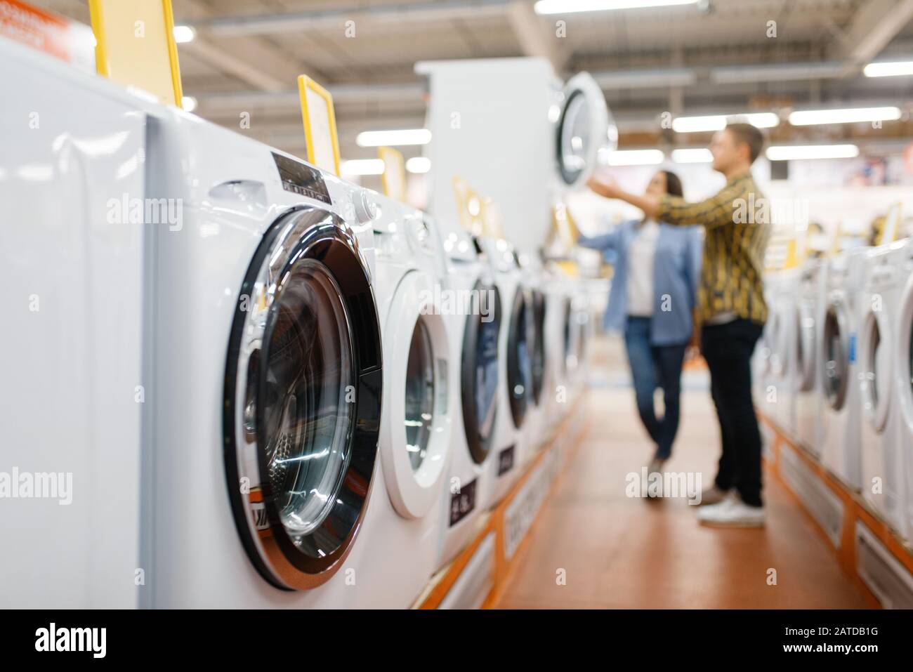 Couple choosing washing machine, electronics store Stock Photo - Alamy