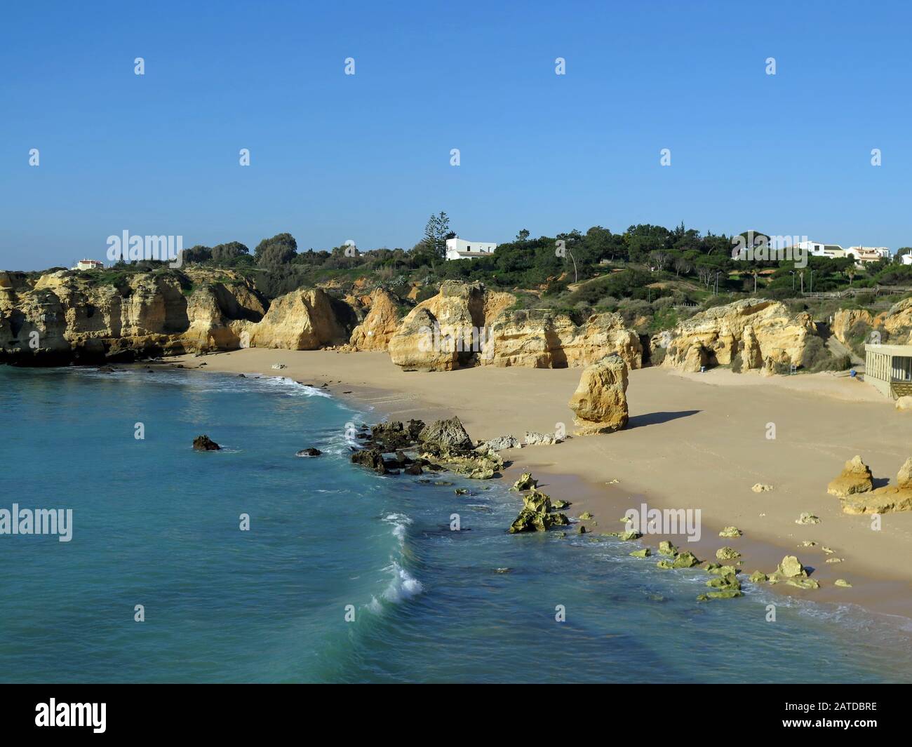 Between the sea and the steep cliffs is a fine sandy beach area Stock ...