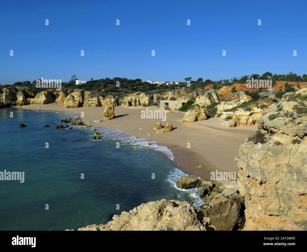 Between the sea and the steep cliffs is a fine sandy beach area Stock ...