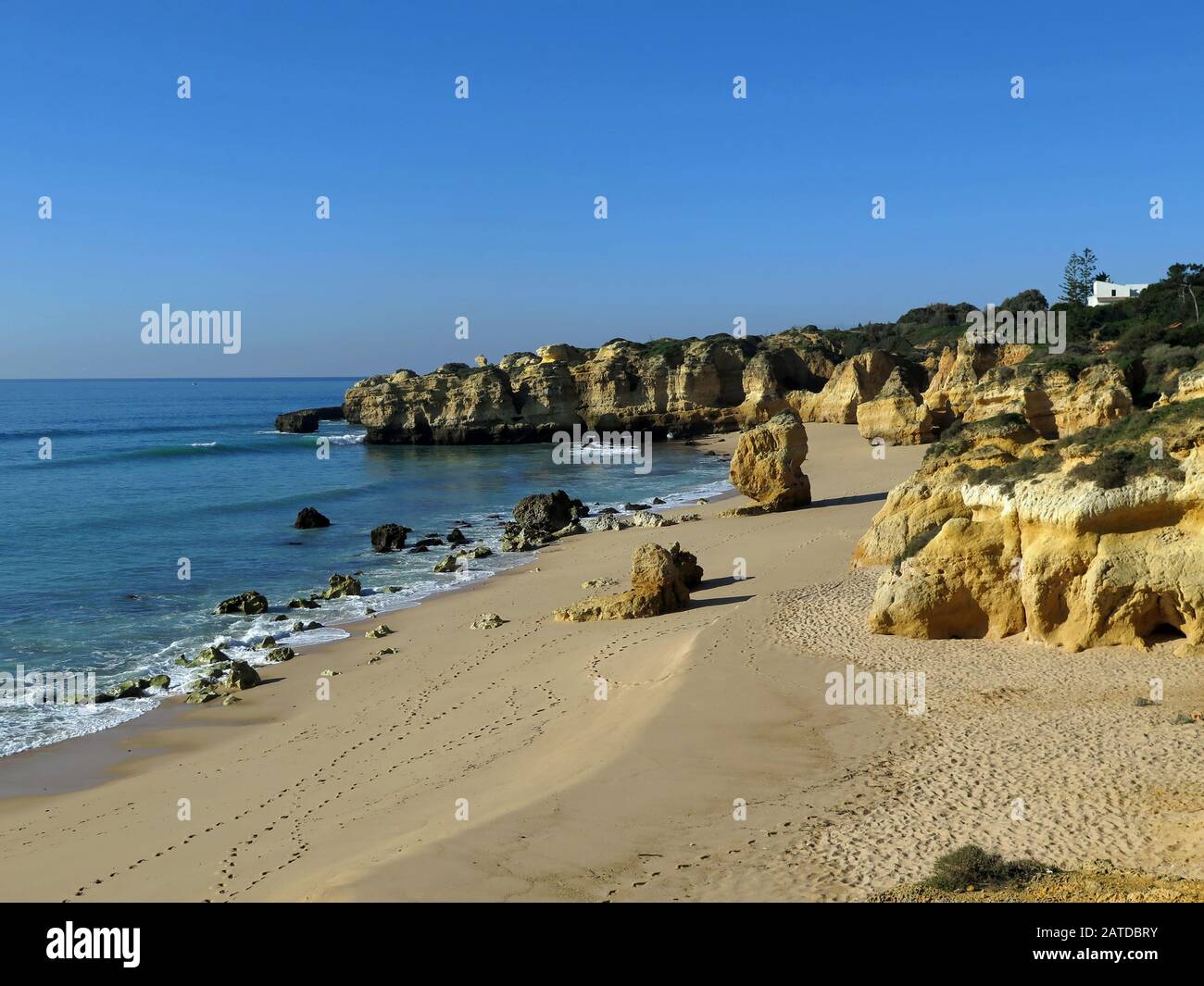 Between the sea and the steep cliffs is a fine sandy beach area Stock ...