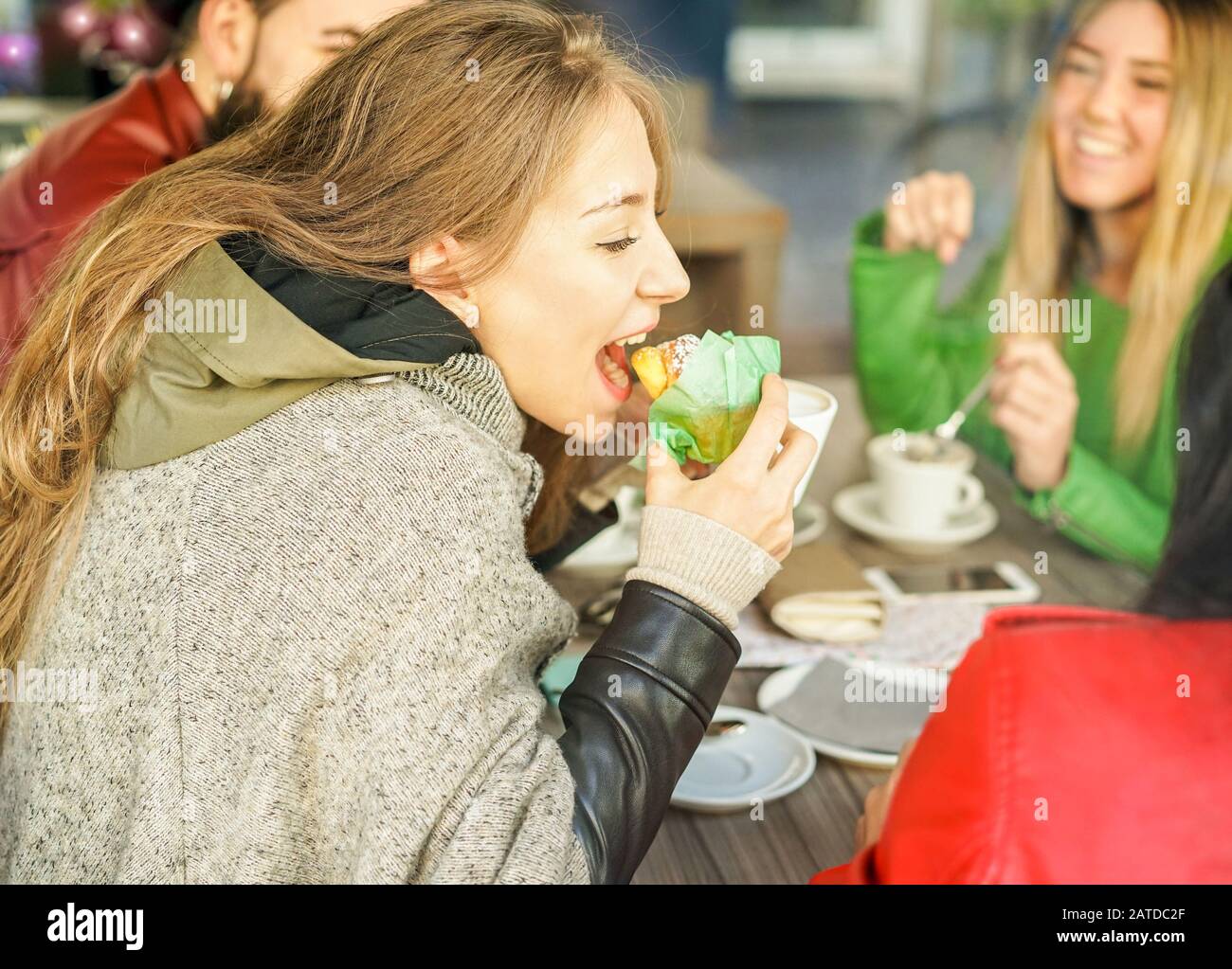 Happy friends eating breakfast and drinking coffee cappuccino at bar ...