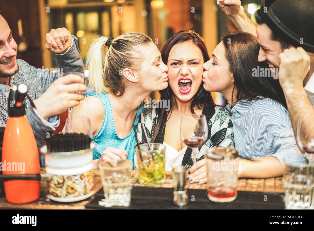 Trendy friends drinking cocktails and wine in hostel bar at happy hour ...