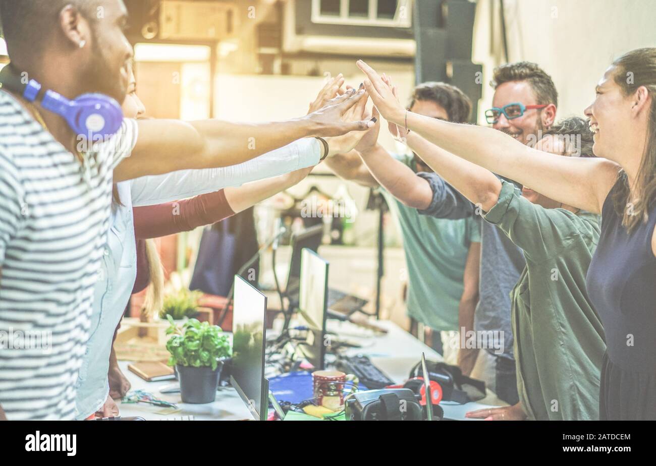 Teamwork putting hands up for the new successful startup project ...