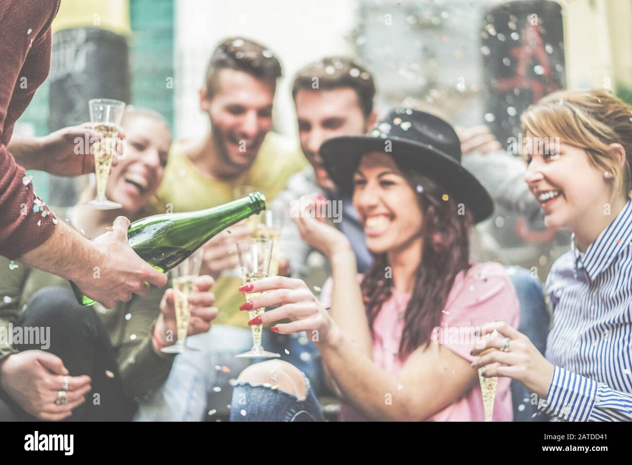 Happy friends celebrating drinking champagne and making party outdoor ...