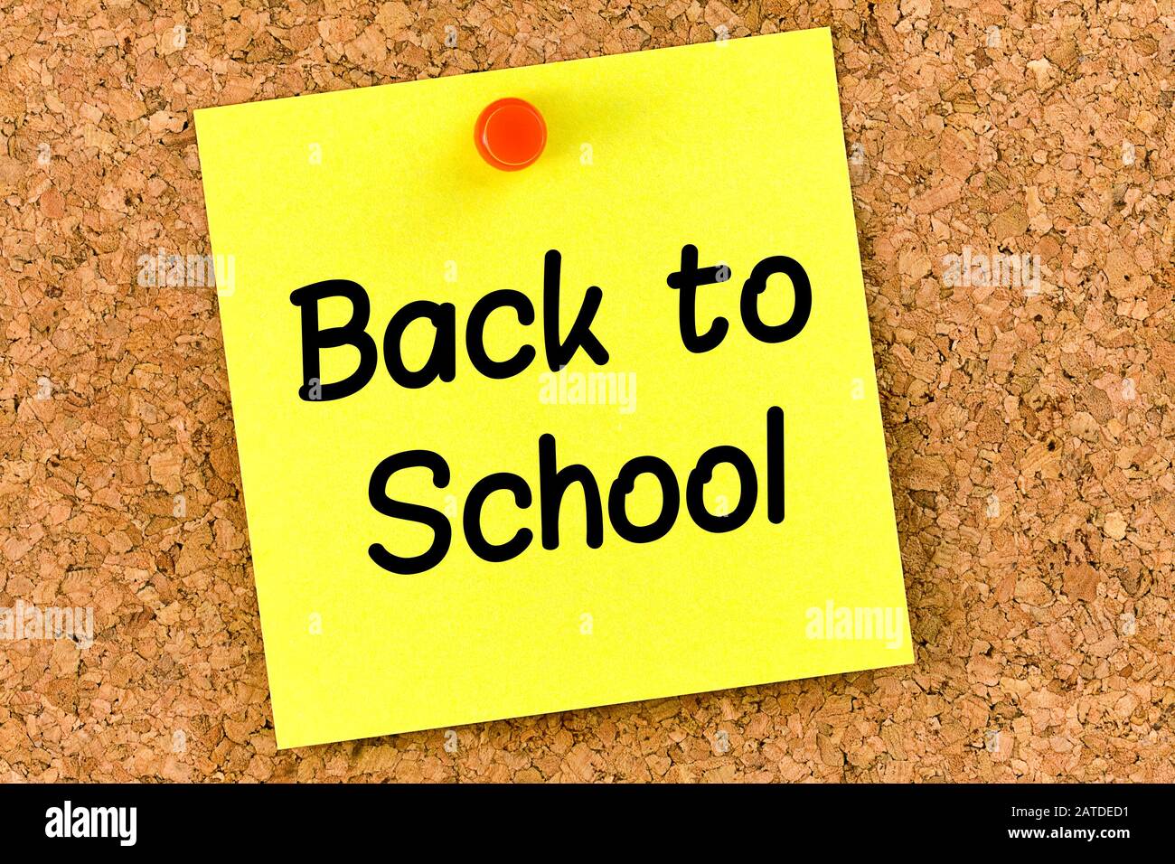 closeup post it note on corkboard with back to school message on it ...