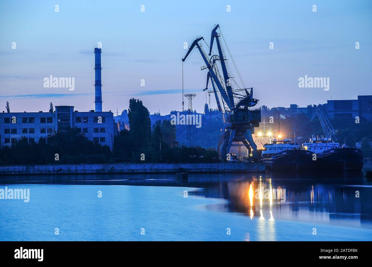 Industrial cranes of reflection in the water. Shipbuilding Plant in ...