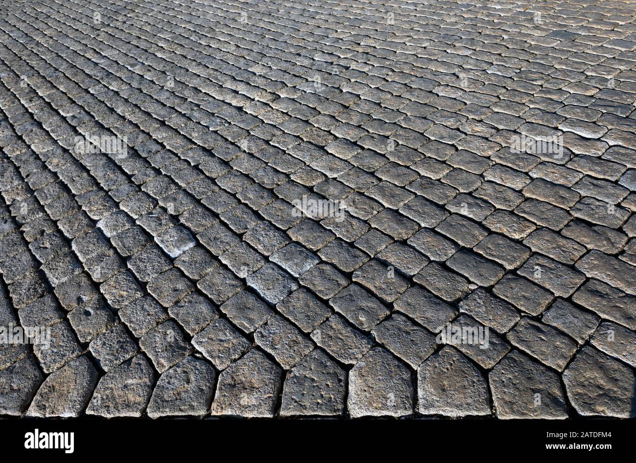 Unique pavement in a street of grey stones. Cobbled road close-up ...