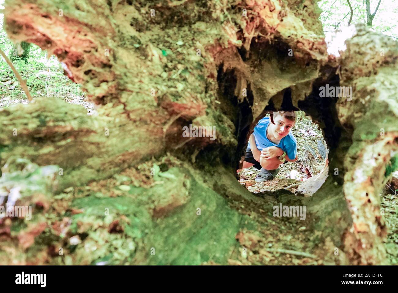 Boy fun exploring in mountain caves Stock Photo - Alamy