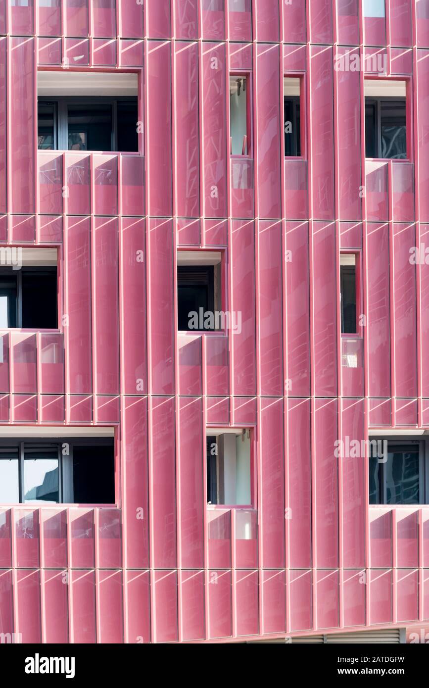Pink exterior cladding on an unfinished building being built in inner ...