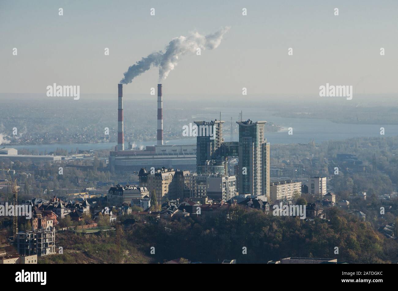 Air pollution by smoke coming out of two factory chimneys. Industrial ...
