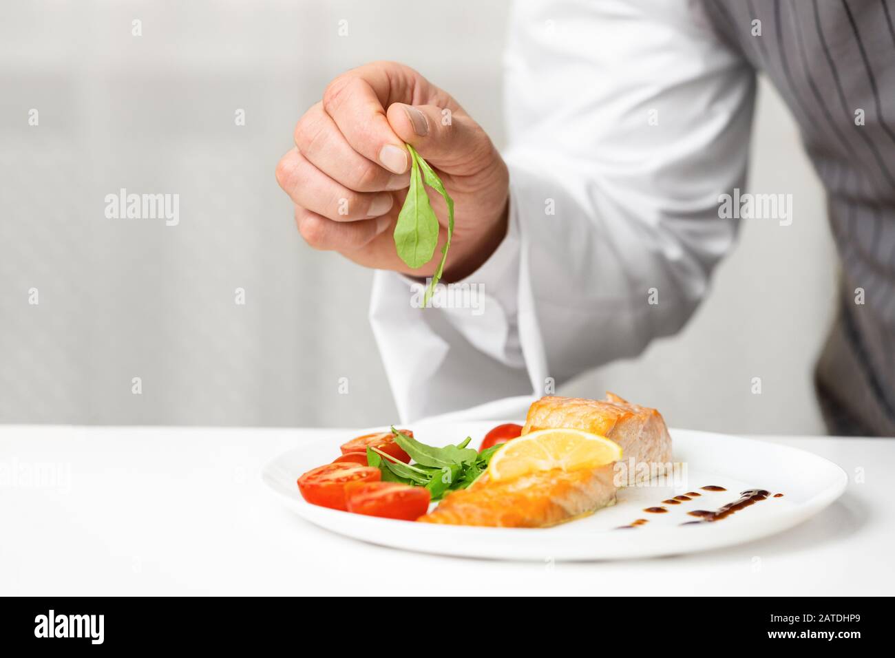 Male Chef Plating Fish Dish Standing In Kitchen, Cropped Stock Photo ...
