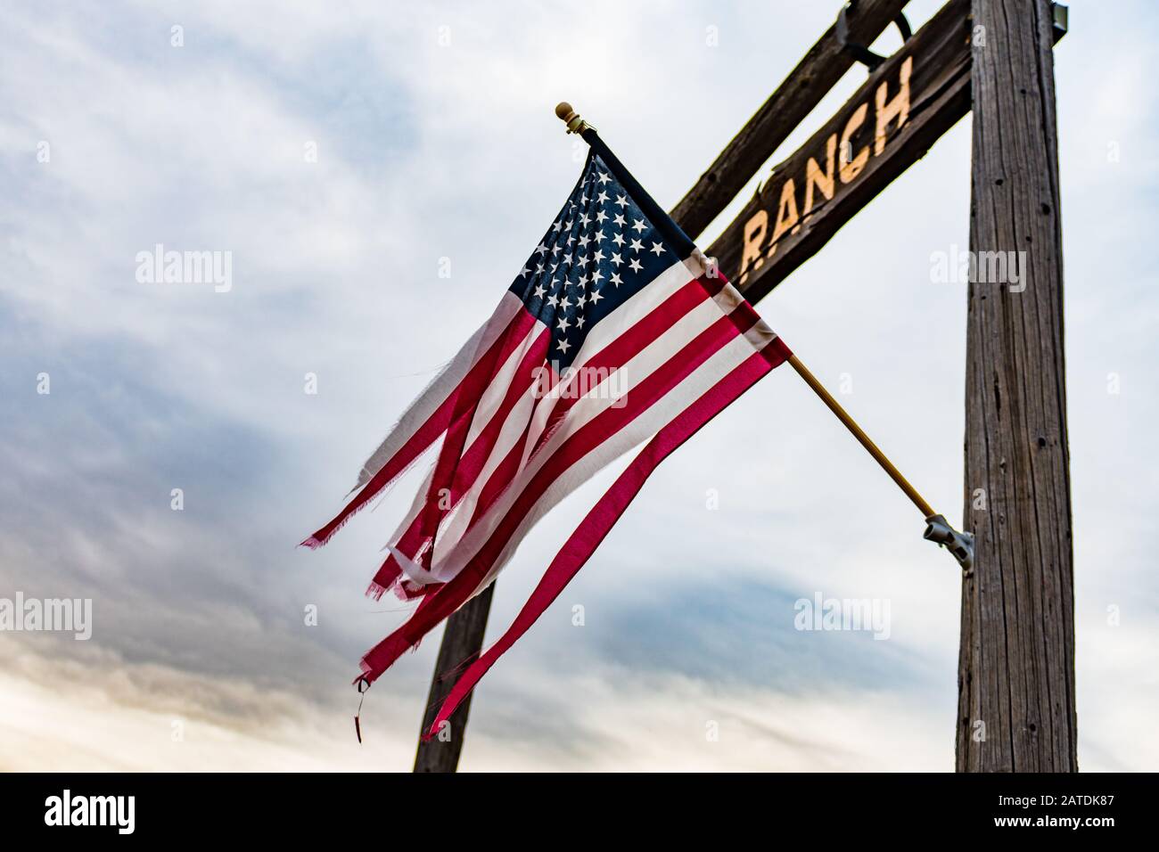 A woven USA flag flies in the entrance arch of a ranch in Oregon Stock ...