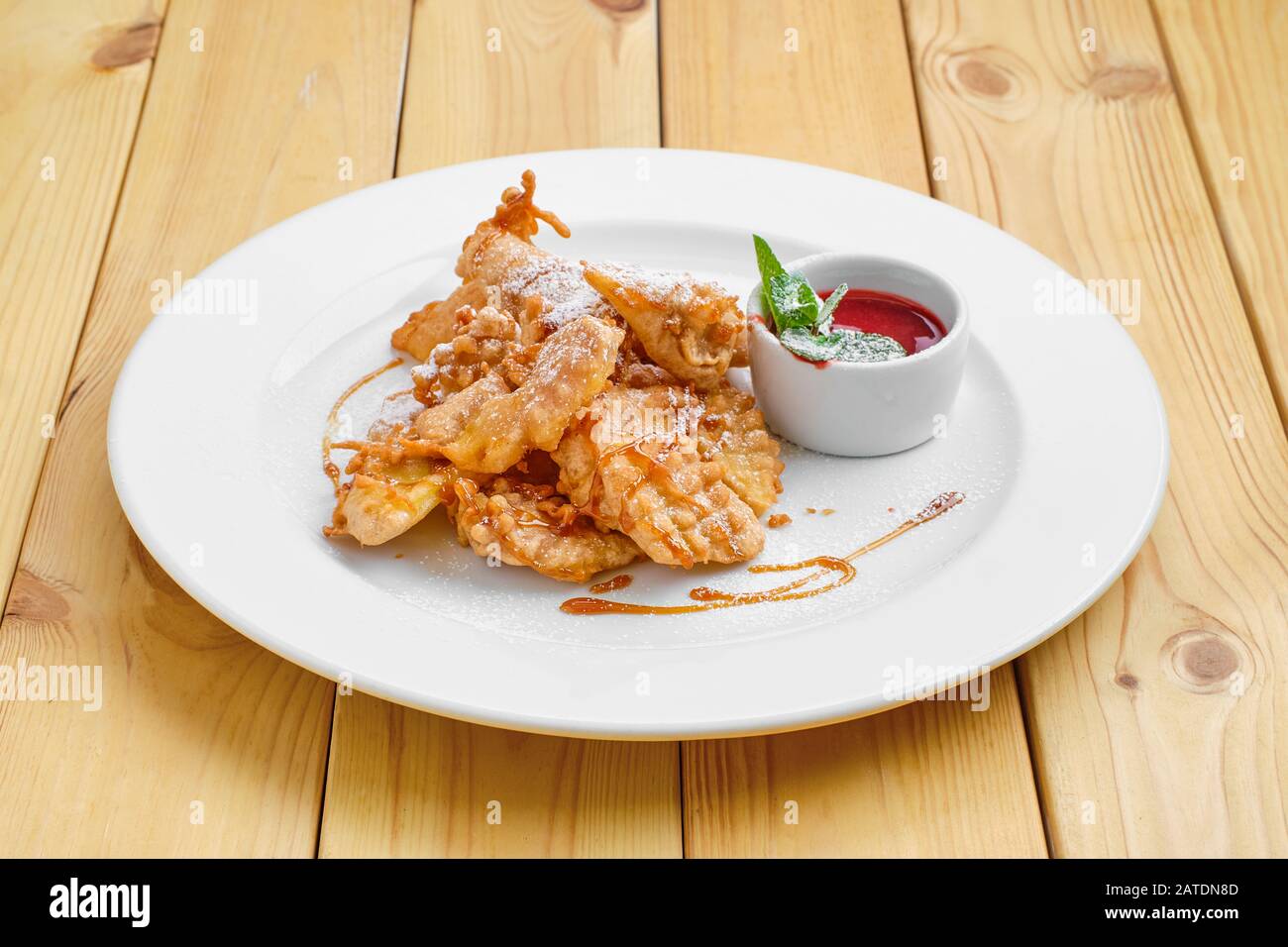 Deep fried fruits in breading served with caramel and strawberry jam ...