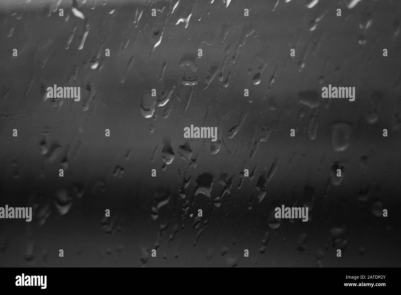 Window in raindrops. Water drops on dark glass closeup, bw photo Stock ...