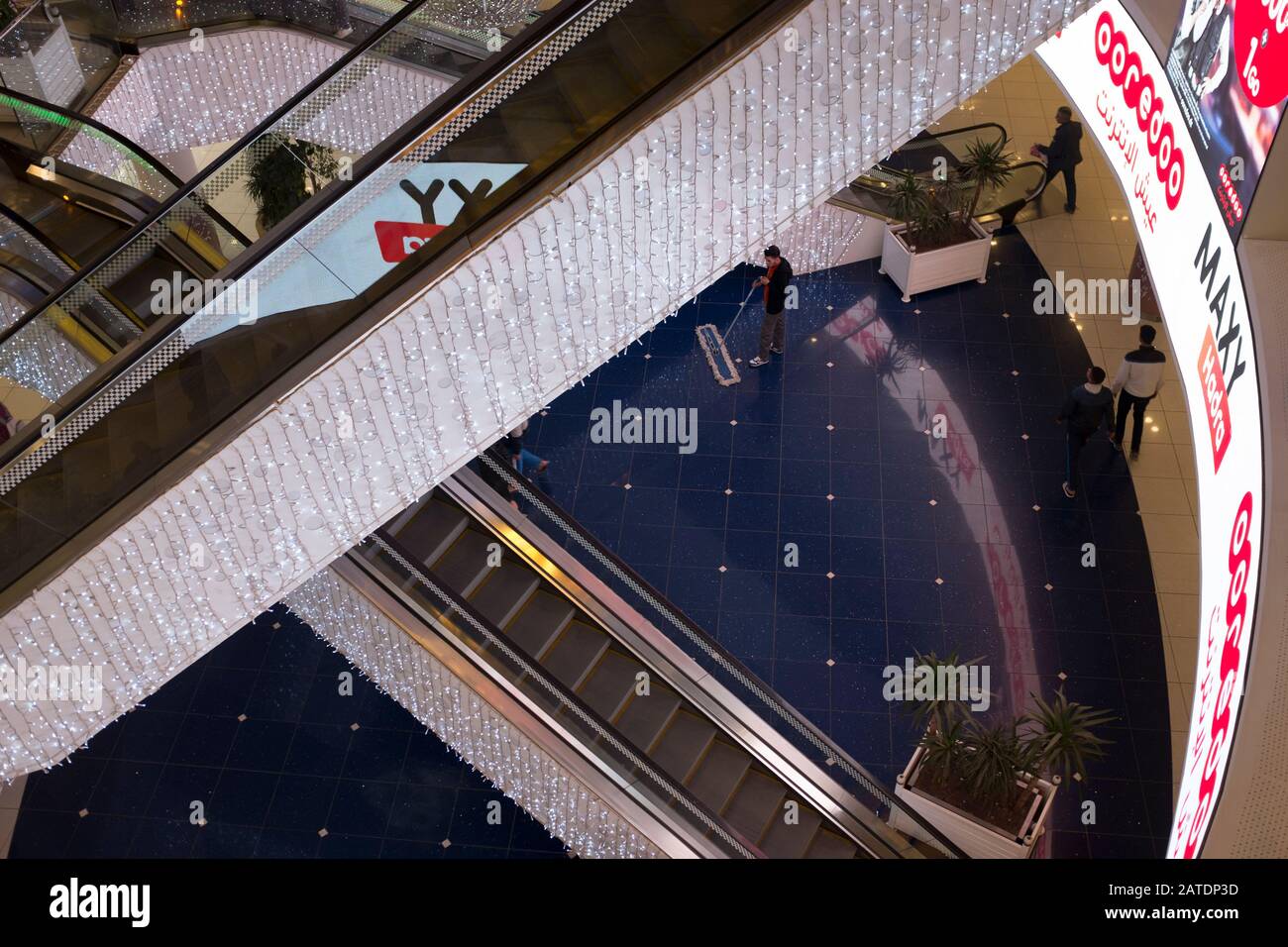 Escalators criss cross each other in . a modern shopping mall in Setif ...