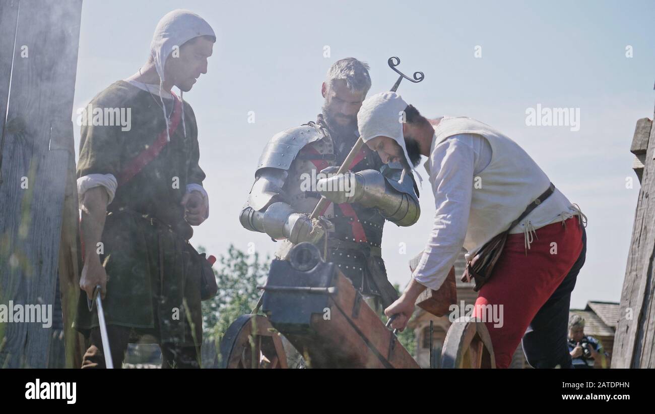 Knights in offensive. Artilleryist shoot from the cannon. Historical ...