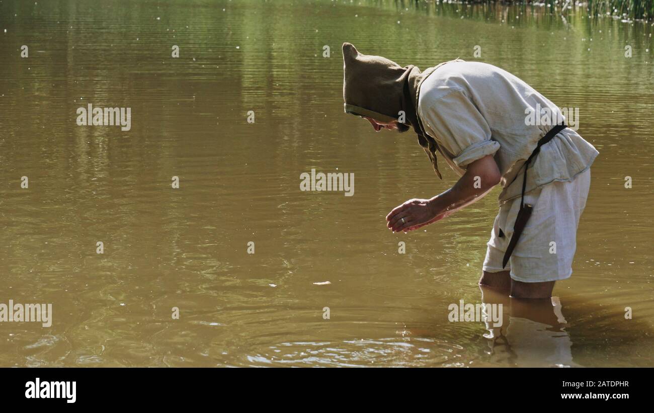 Medieval fishing. Man wearing traditional medieval clothes Stock Photo ...
