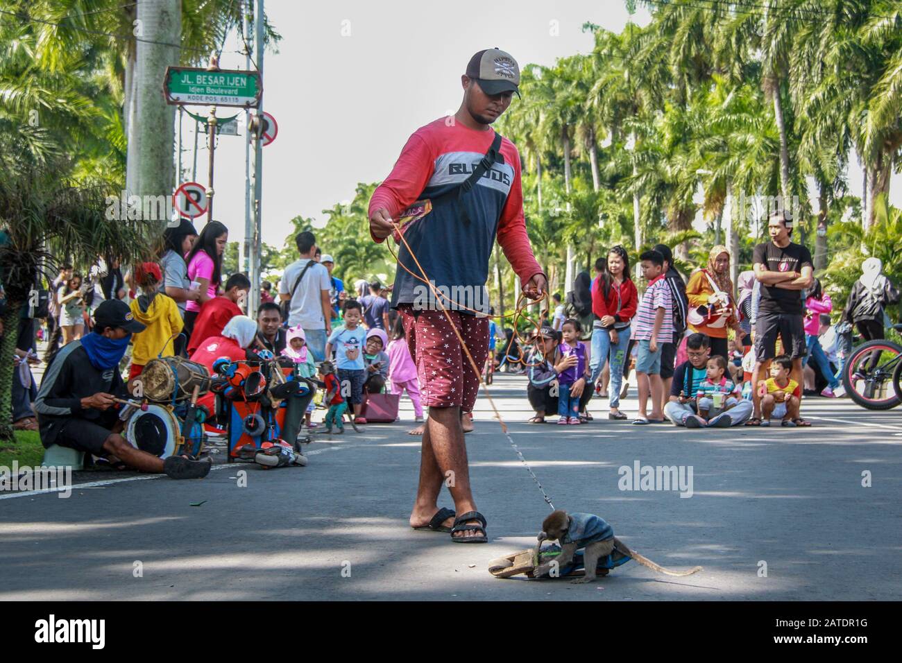People watch a Topeng Monyet during the show in Malang.Topeng monyet or ...