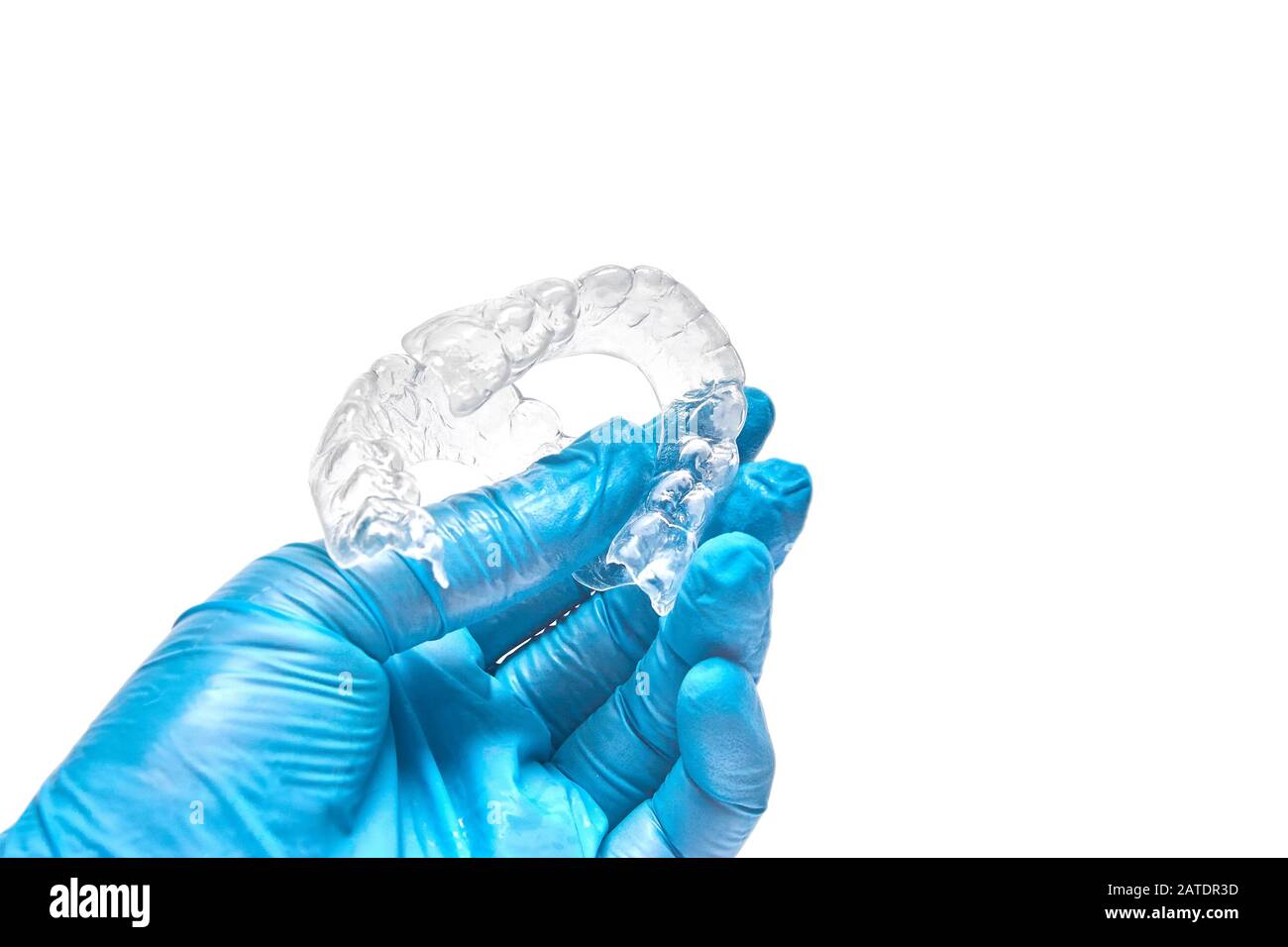 Hand is holding set of custom dental trays for bleaching teeth ...