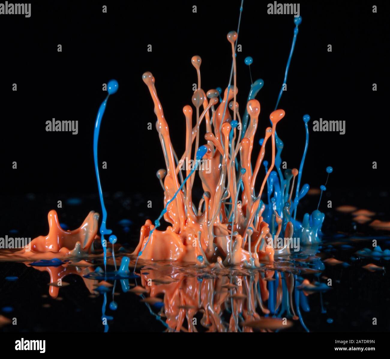 orange ink splash on a black background Stock Photo - Alamy