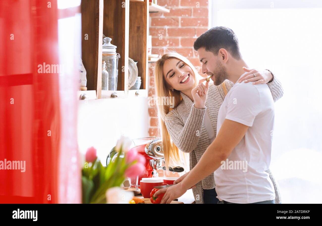 Beautiful young girlfriend feeding boyfriend and smiling Stock Photo ...