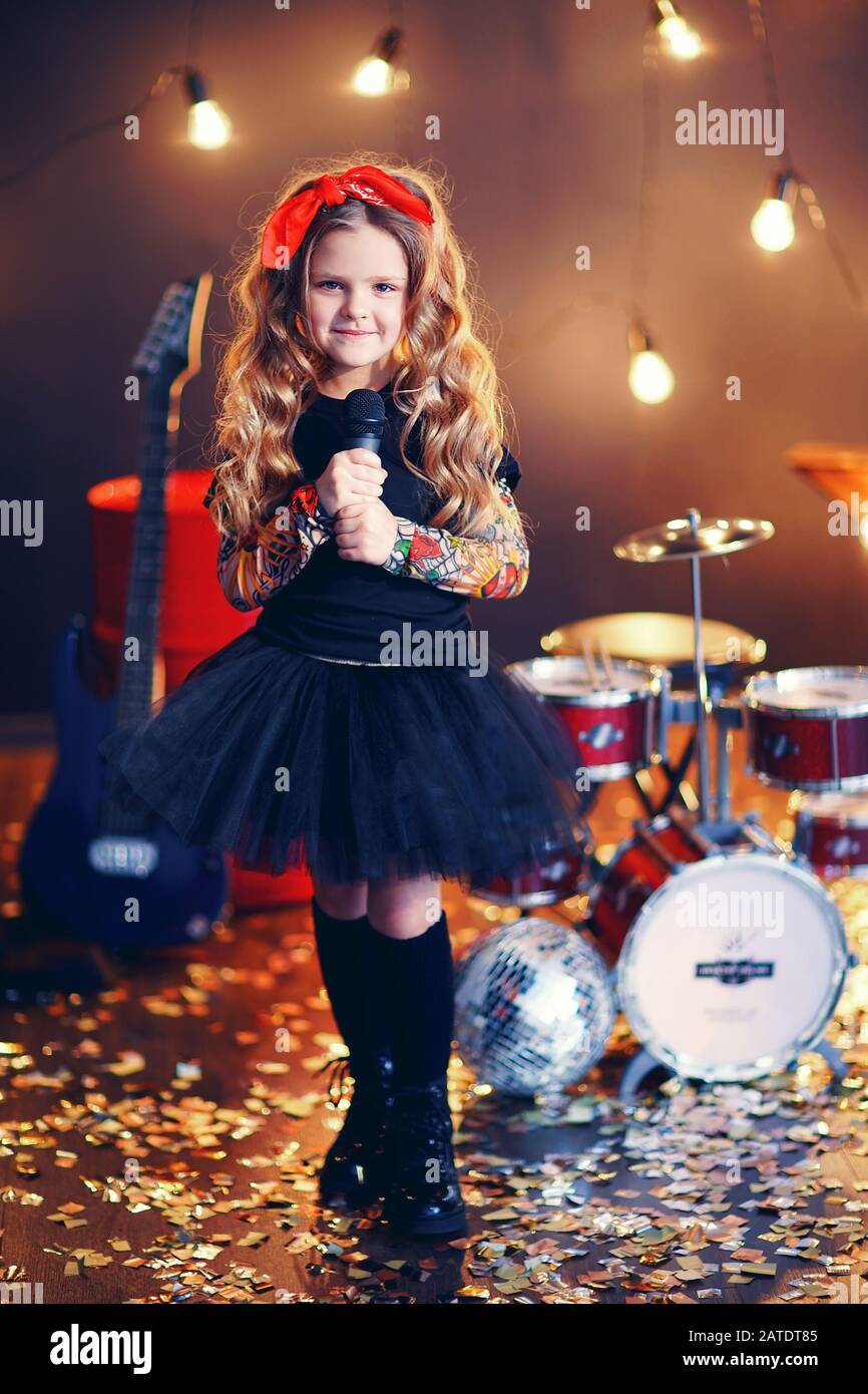 little beautiful girl with curly hair singing in recording studio Stock ...