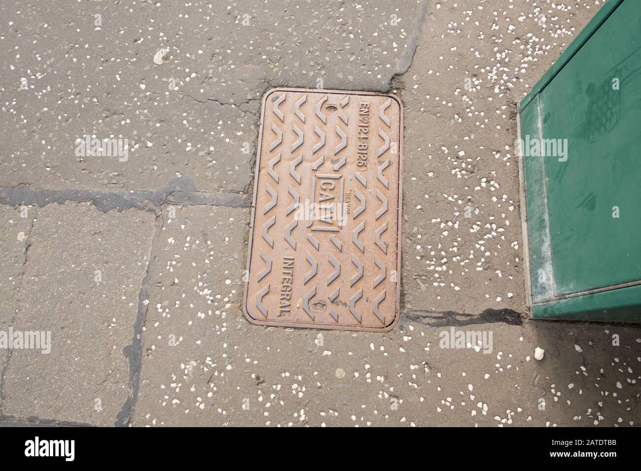 Close-up of metal manhole cover for cable TV or CATV (fibre optic) and ...