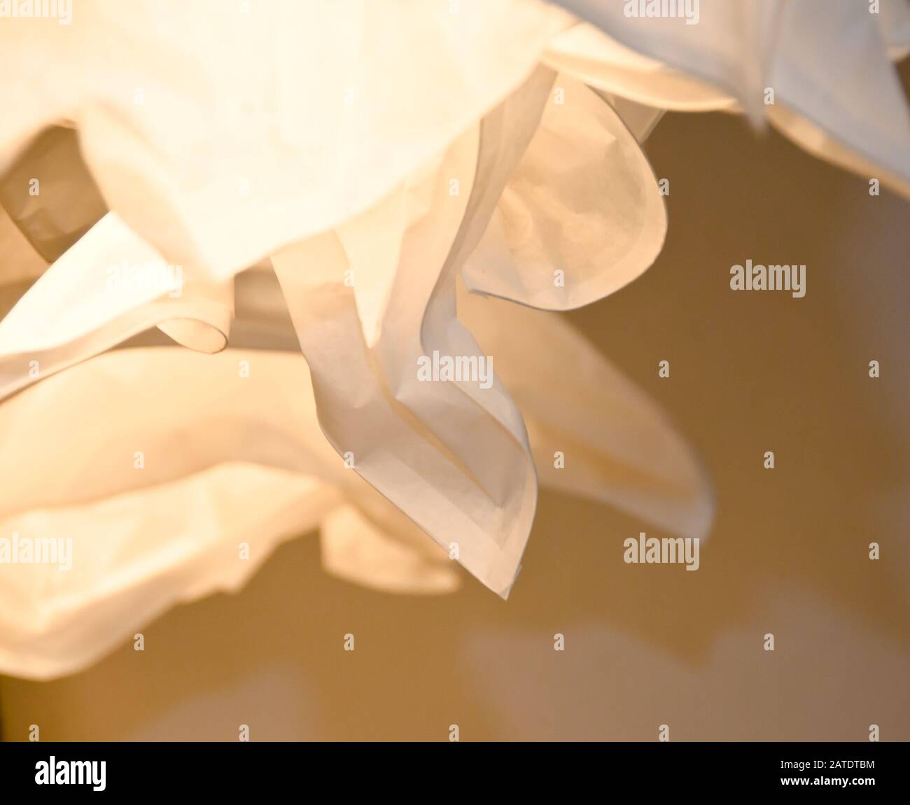 warm and yellow light falls through different layers of paper, light ...