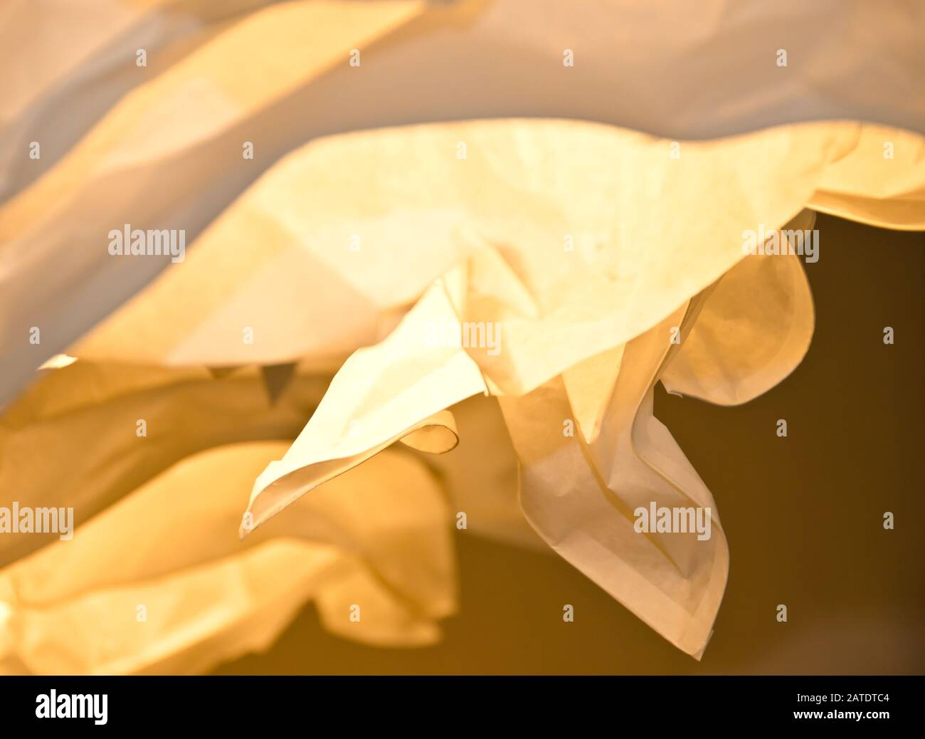 warm and yellow light falls through different layers of paper, light ...