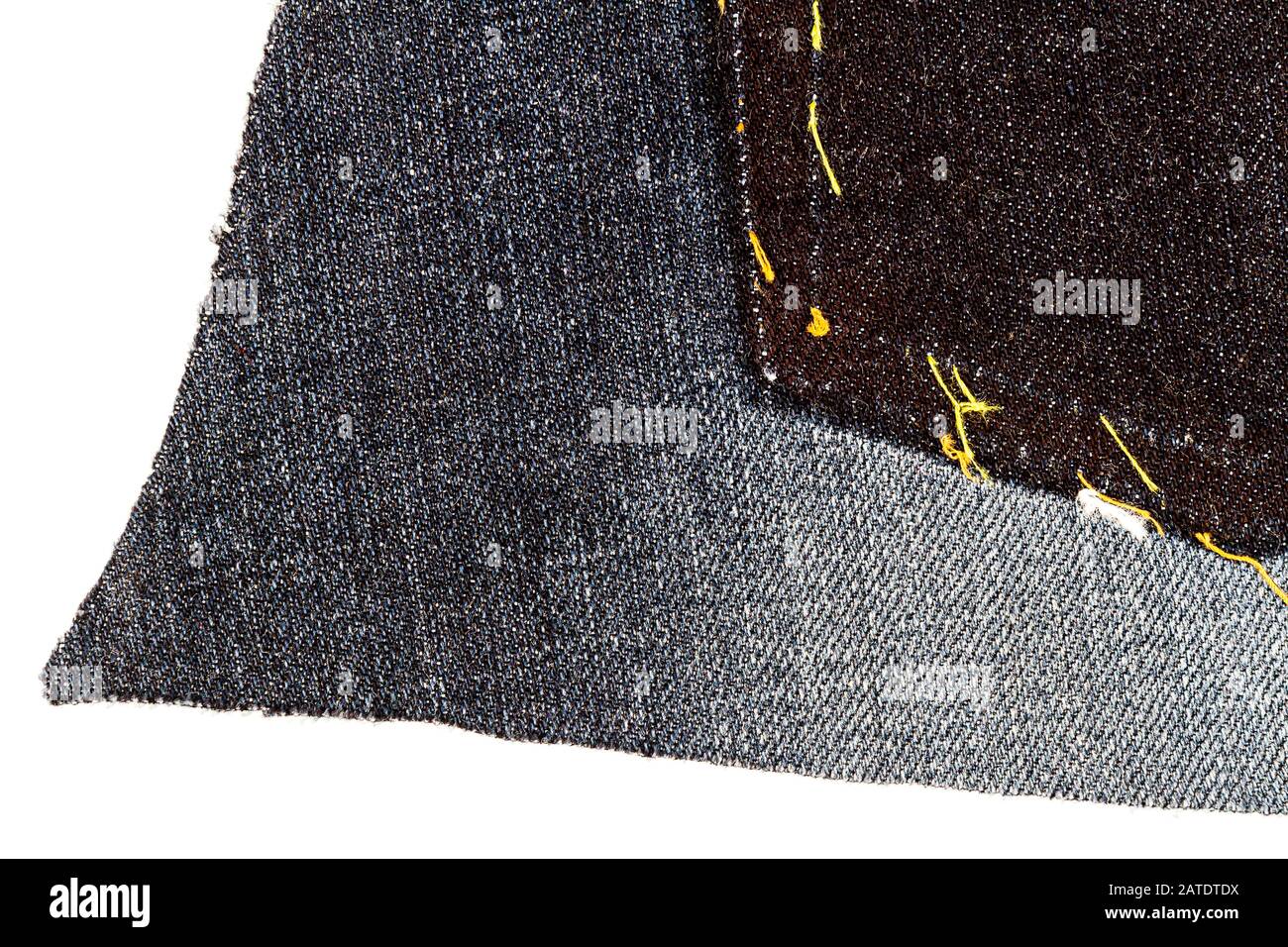 Piece of black jeans fabric with a ripped of back pocket isolated on ...