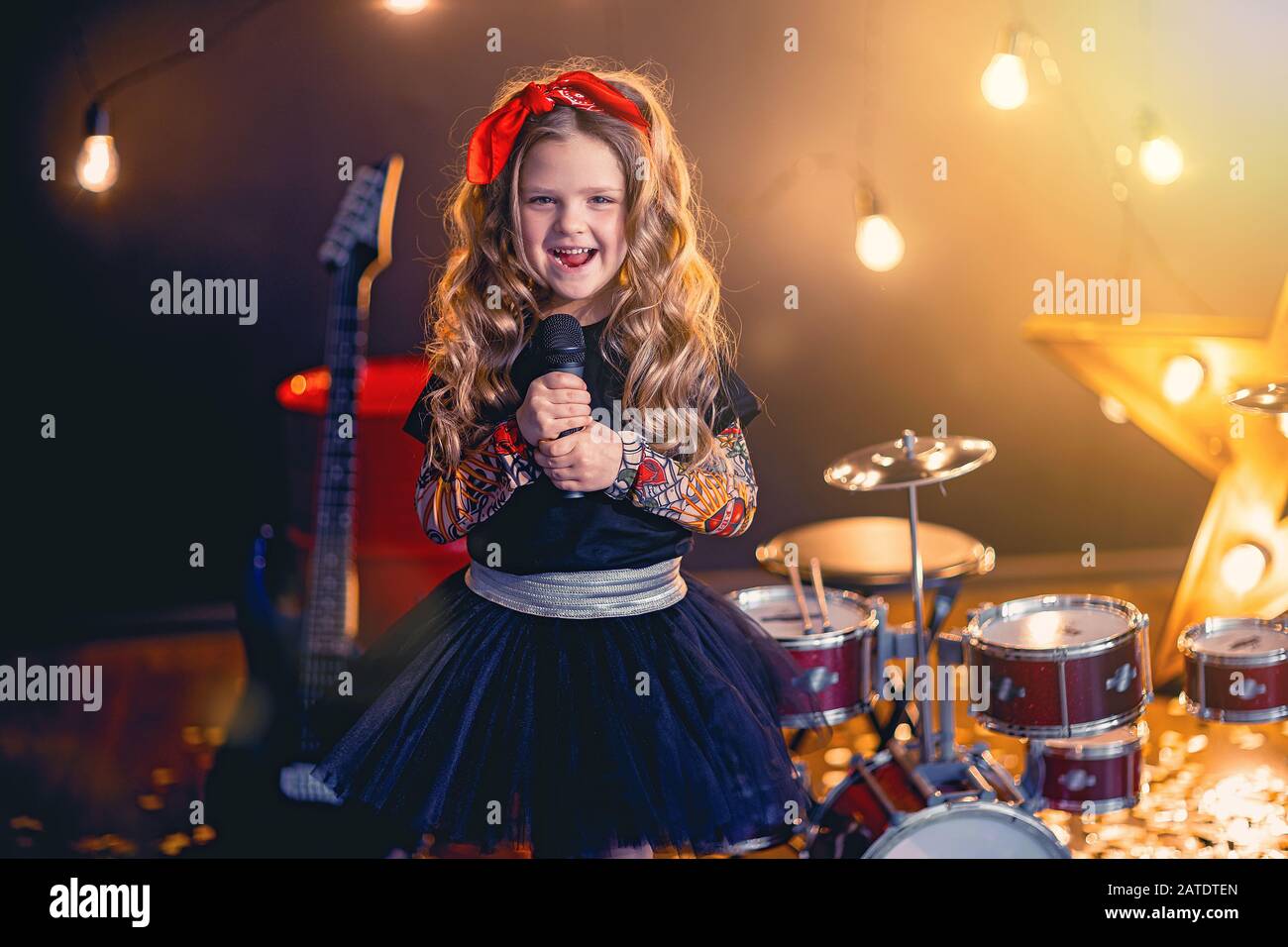 little beautiful girl with curly hair singing in recording studio Stock ...