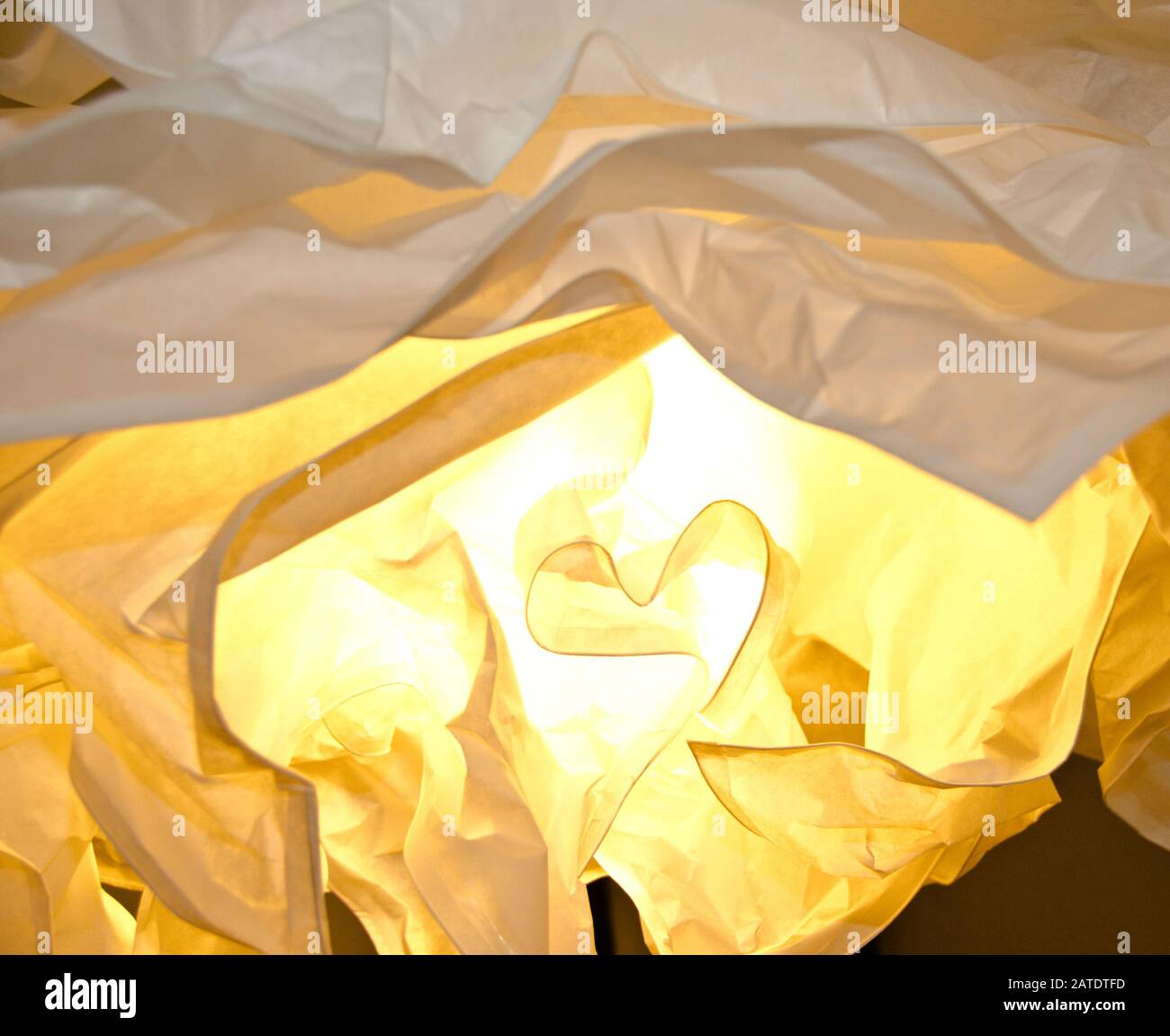 warm and yellow light falls through different layers of paper, light ...