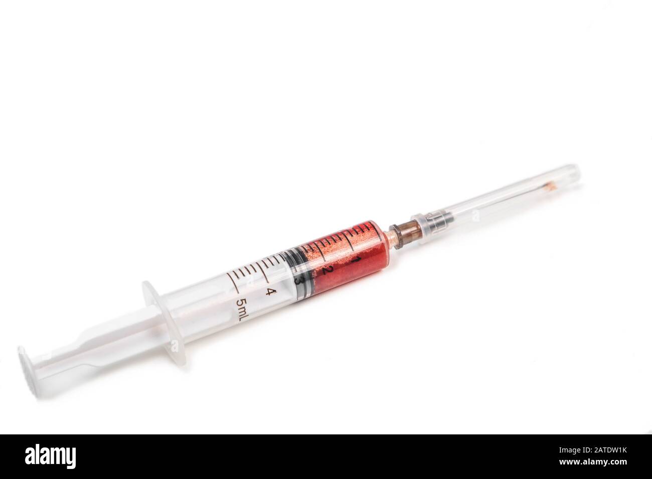 disposable sterile syringe filled with blood on a white isolated ...