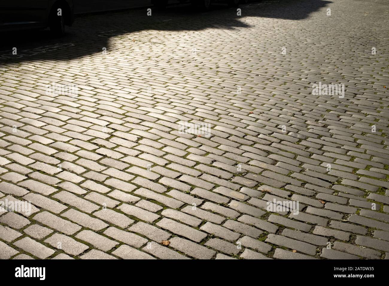 Cobbled street shot into the sun, in New Town, Edinburgh, Scotland ...