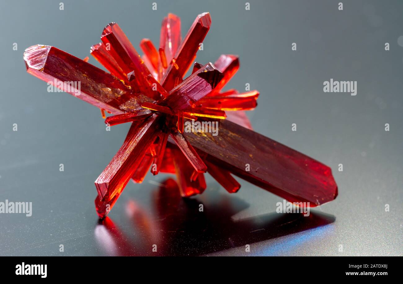 Red crystalline minerals on a black background Stock Photo - Alamy