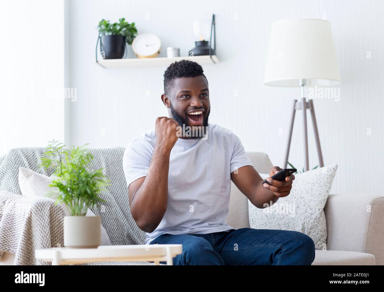 Emotional black guy watching hi-res stock photography and images - Alamy