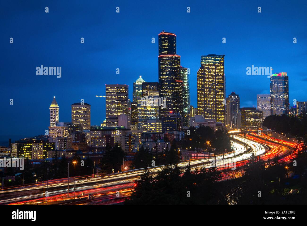 Seattle skyline at sunrise during rush hour traffic with light trails ...