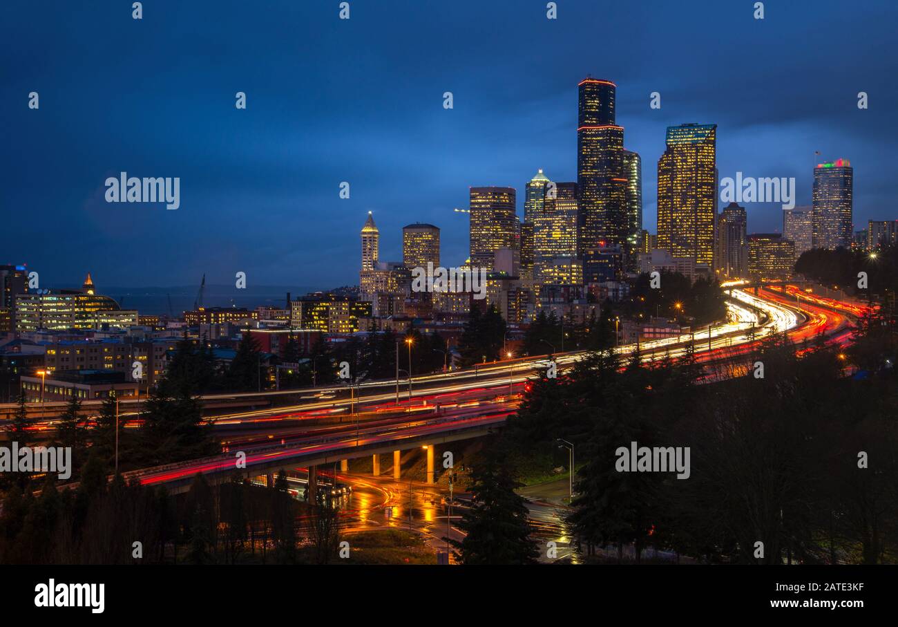 Seattle skyline at sunrise during rush hour traffic with light trails ...