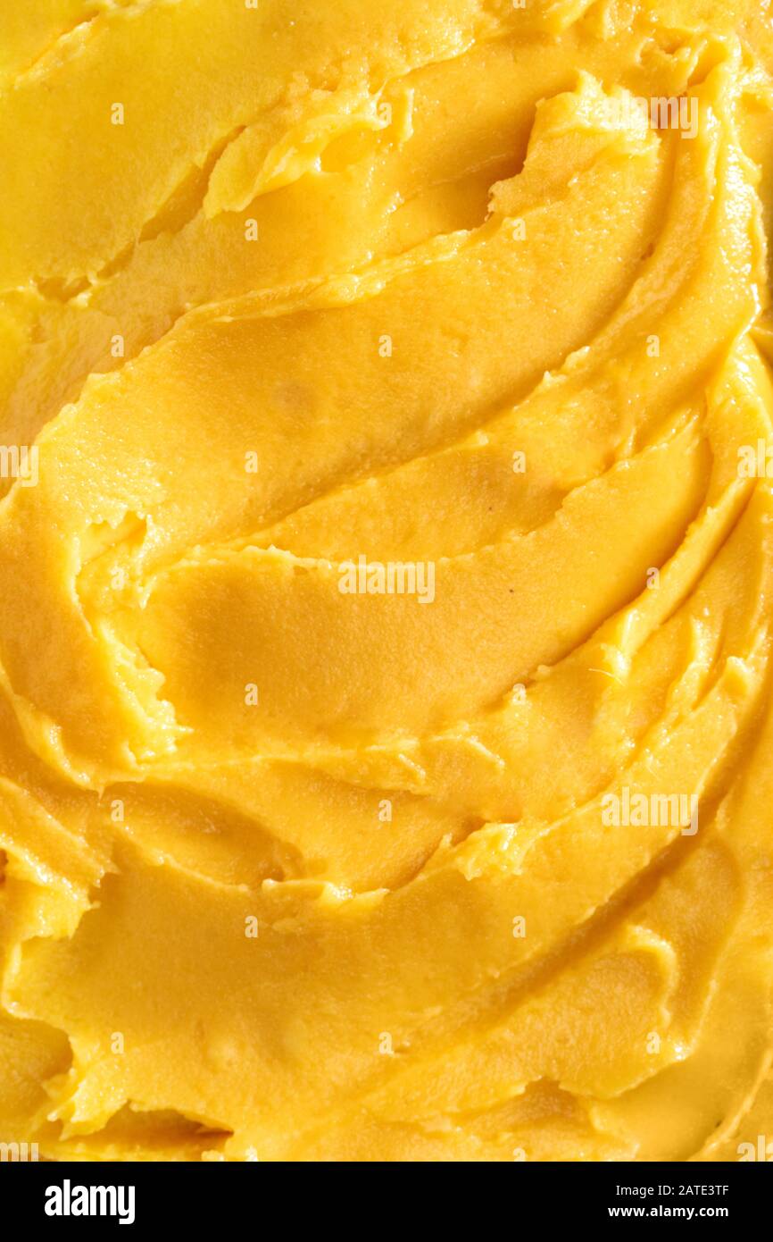 Delicious mango sorbet gelato in a full frame background texture viewed ...