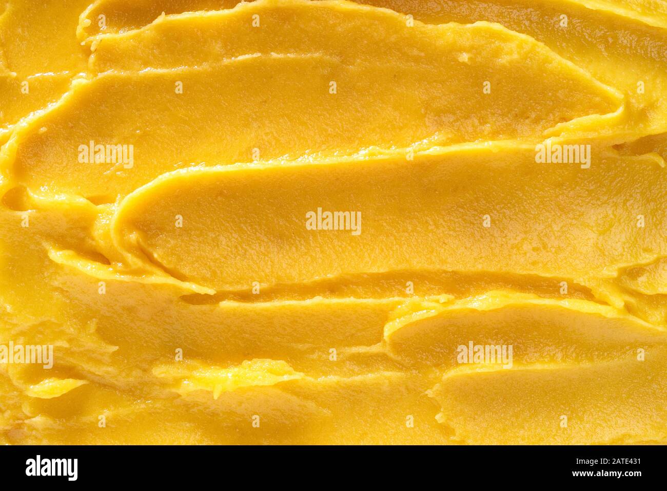 Delicious mango sorbet gelato in a full frame background texture viewed ...