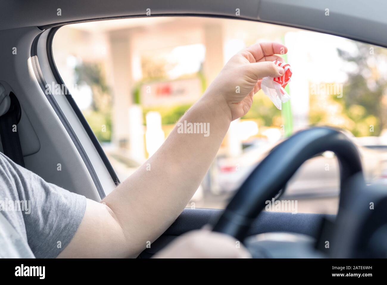Adult male person throwing out paper fast food snack wrap garbage in ...