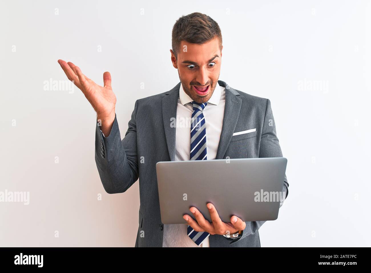 Young handsome business man working using computer laptop over isolated ...