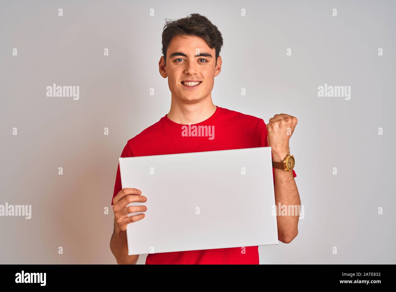 Teenager boy holding advertising banner with blank space over isolated ...