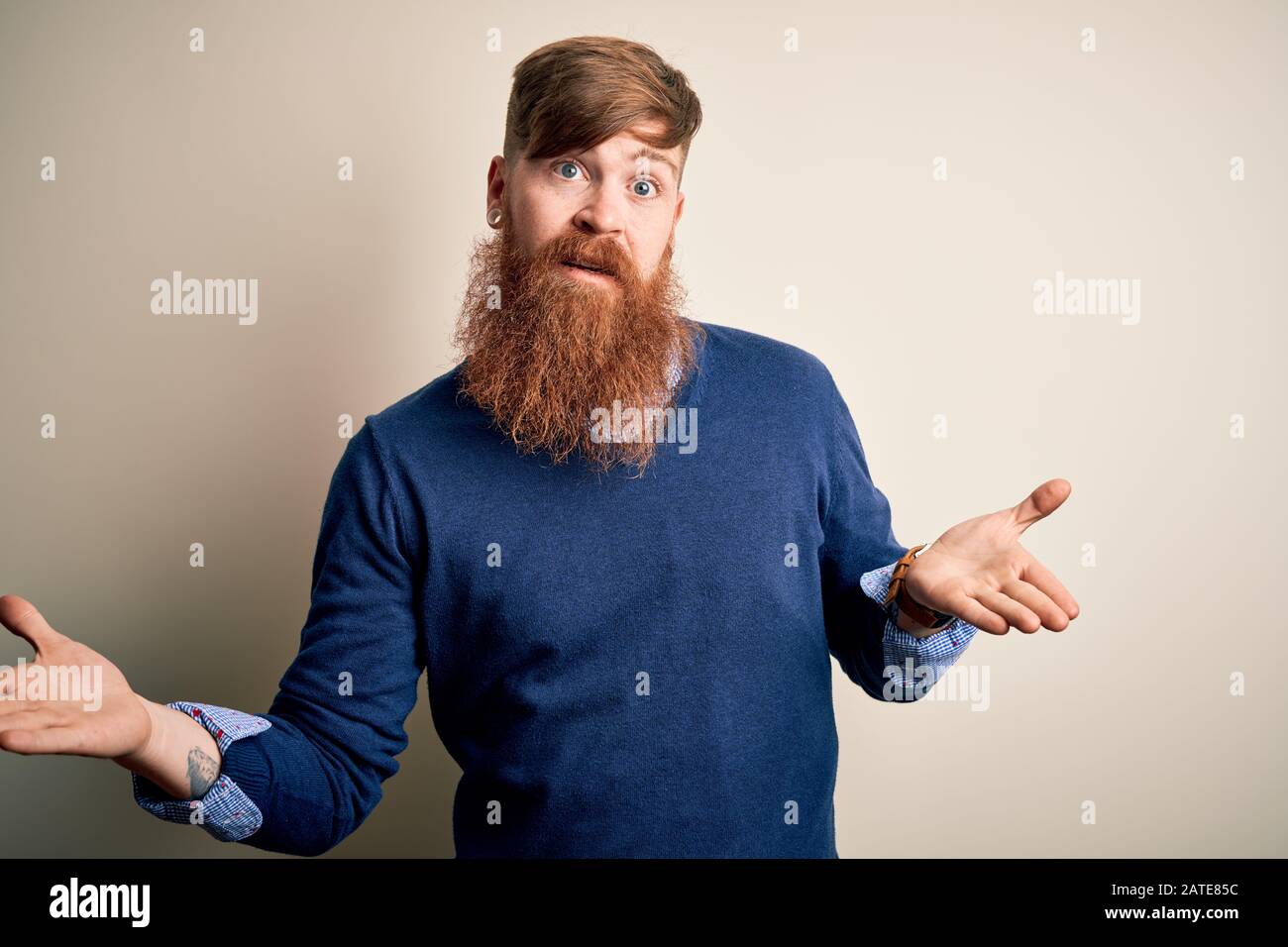 Handsome Irish redhead business man with beard standing over isolated ...