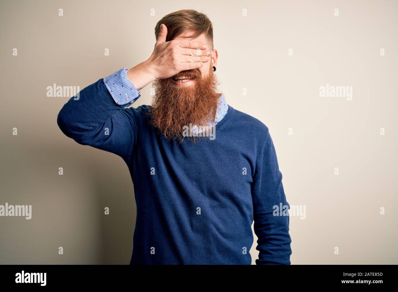 Handsome Irish redhead business man with beard standing over isolated ...