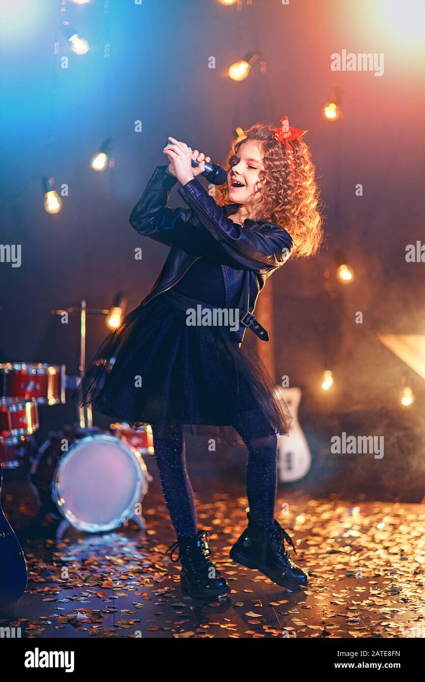 little beautiful girl with curly hair singing in recording studio Stock ...